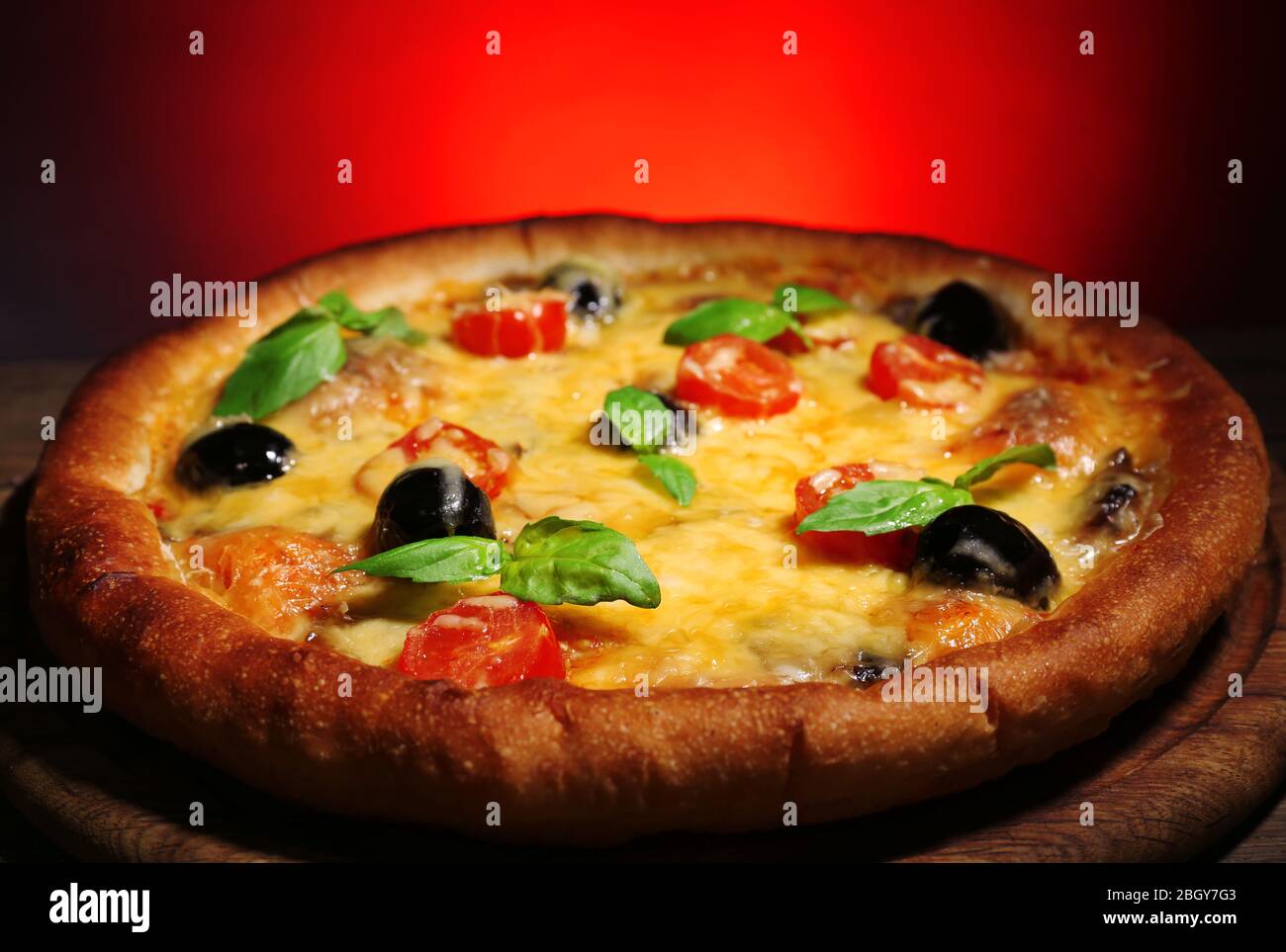 Italian pizza on board and dark colorful background Stock Photo - Alamy