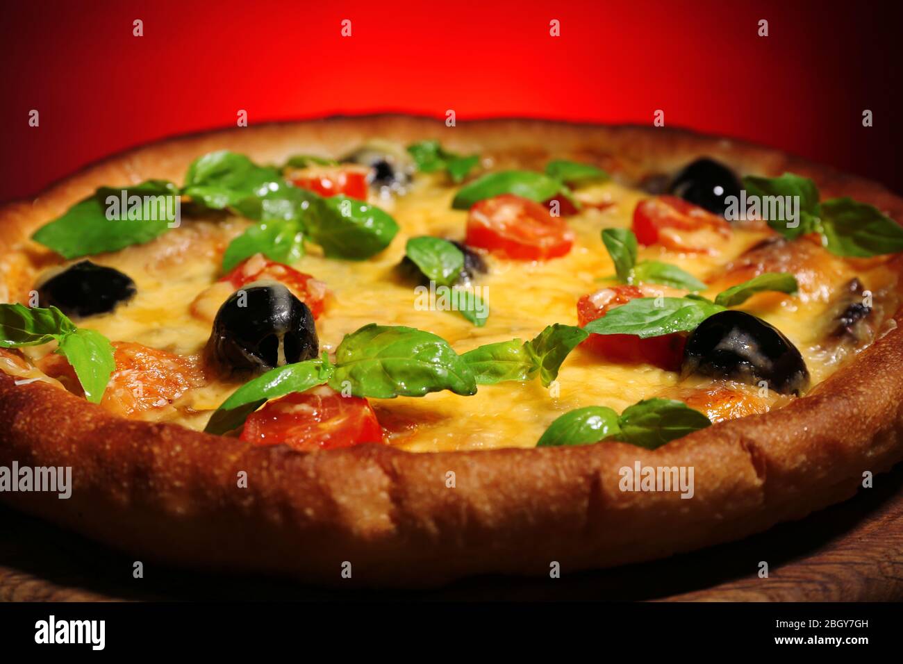 Italian pizza on board and dark colorful background Stock Photo - Alamy