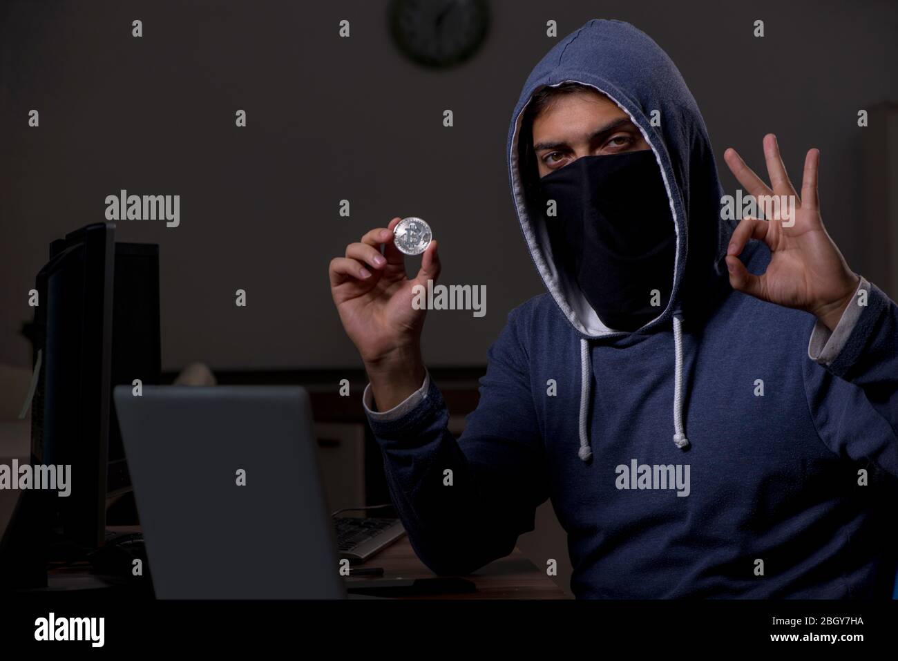 Male hacker hacking security firewall late in the office Stock Photo ...