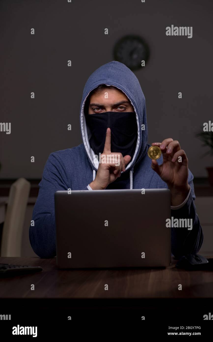Male hacker hacking security firewall late in the office Stock Photo ...