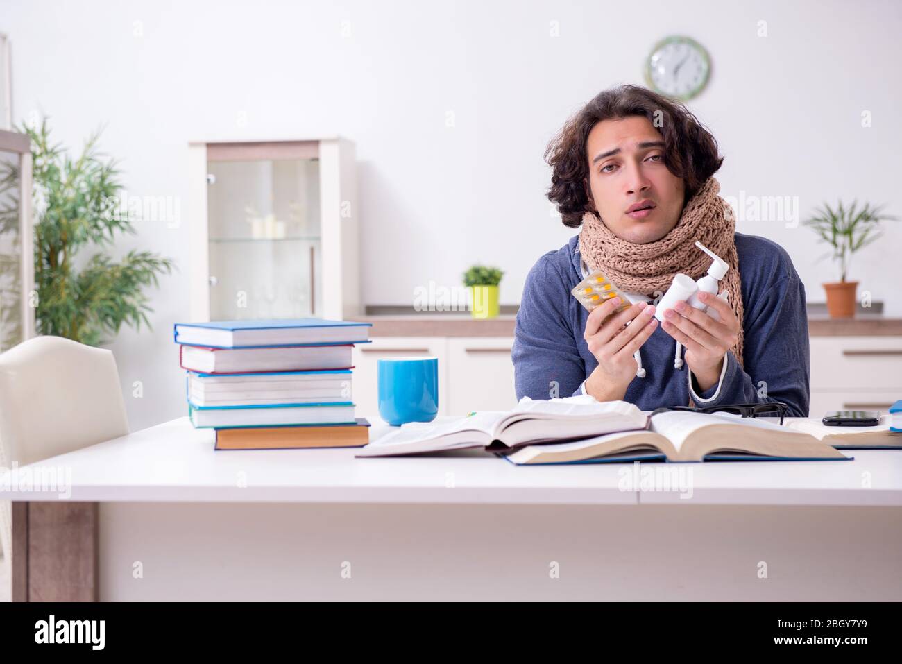 The sick male student suffering at home Stock Photo - Alamy