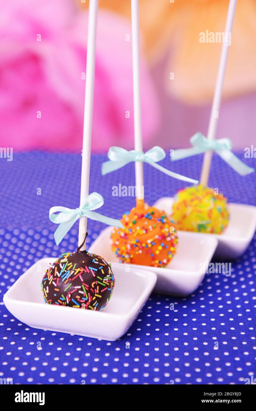Sweet cake pops on table on bright background Stock Photo - Alamy