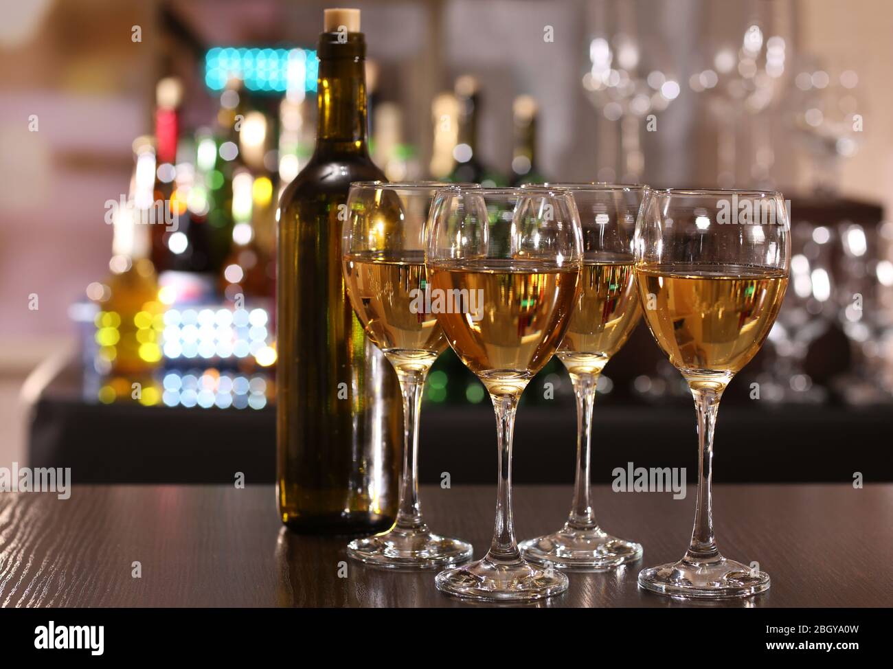 Glasses of wine on counter and bar on background Stock Photo - Alamy