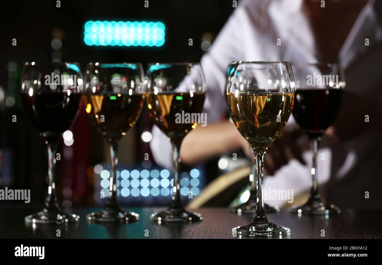Bartender working at counter on bar background Stock Photo - Alamy