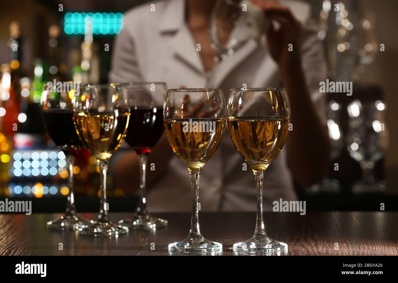 Bartender working at counter on bar background Stock Photo - Alamy