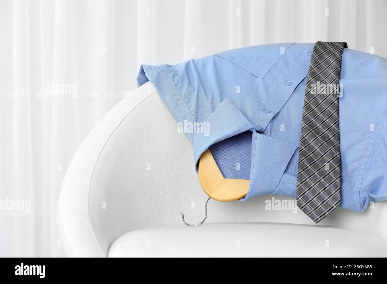 Blue shirt on chair on curtain background Stock Photo - Alamy