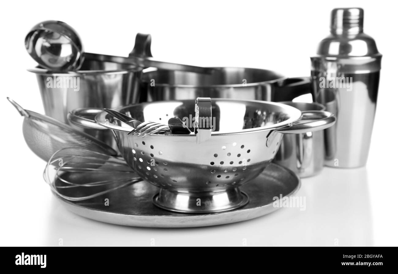 Stainless steel kitchenware on table, isolated on white Stock Photo - Alamy
