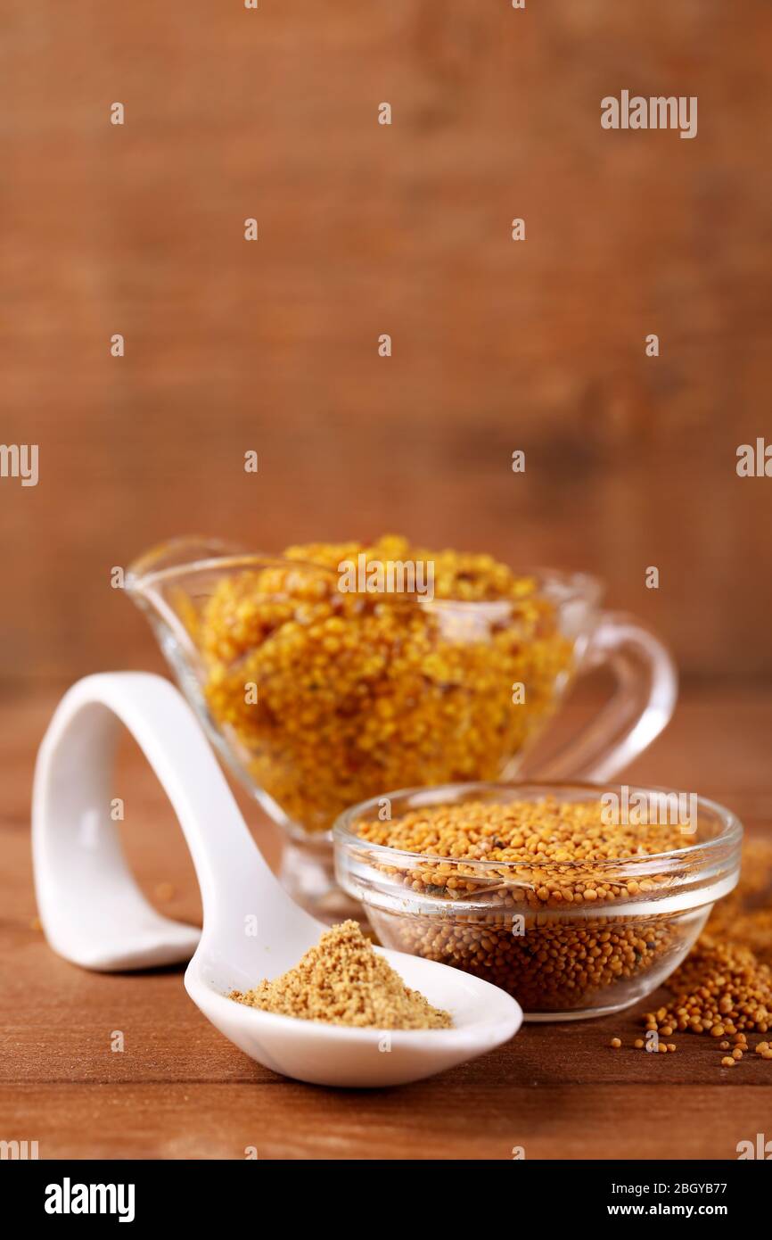Composition of different kinds of mustard on color wooden background ...