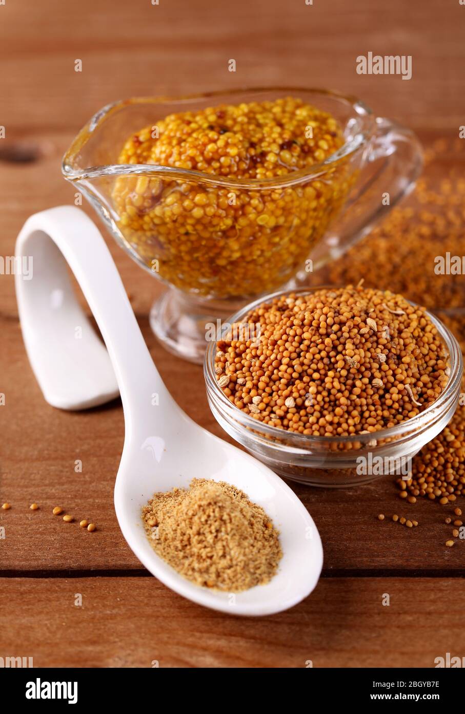 Composition of different kinds of mustard on color wooden background ...