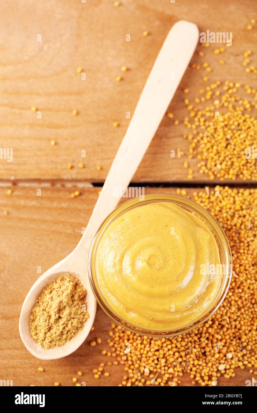 Composition of different kinds of mustard on wooden background Stock ...
