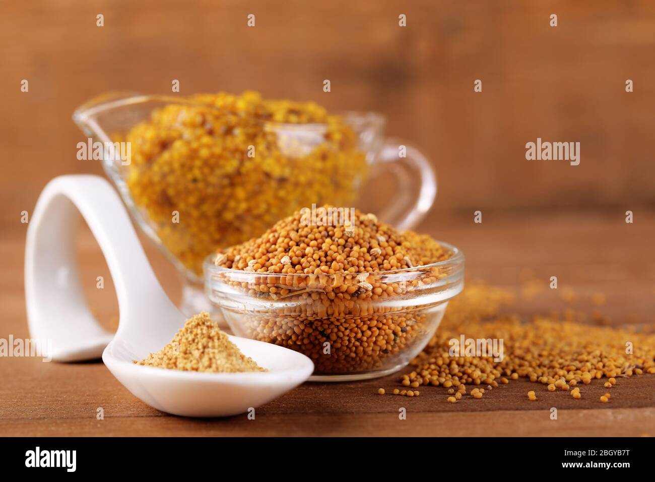 Composition of different kinds of mustard on color wooden background ...