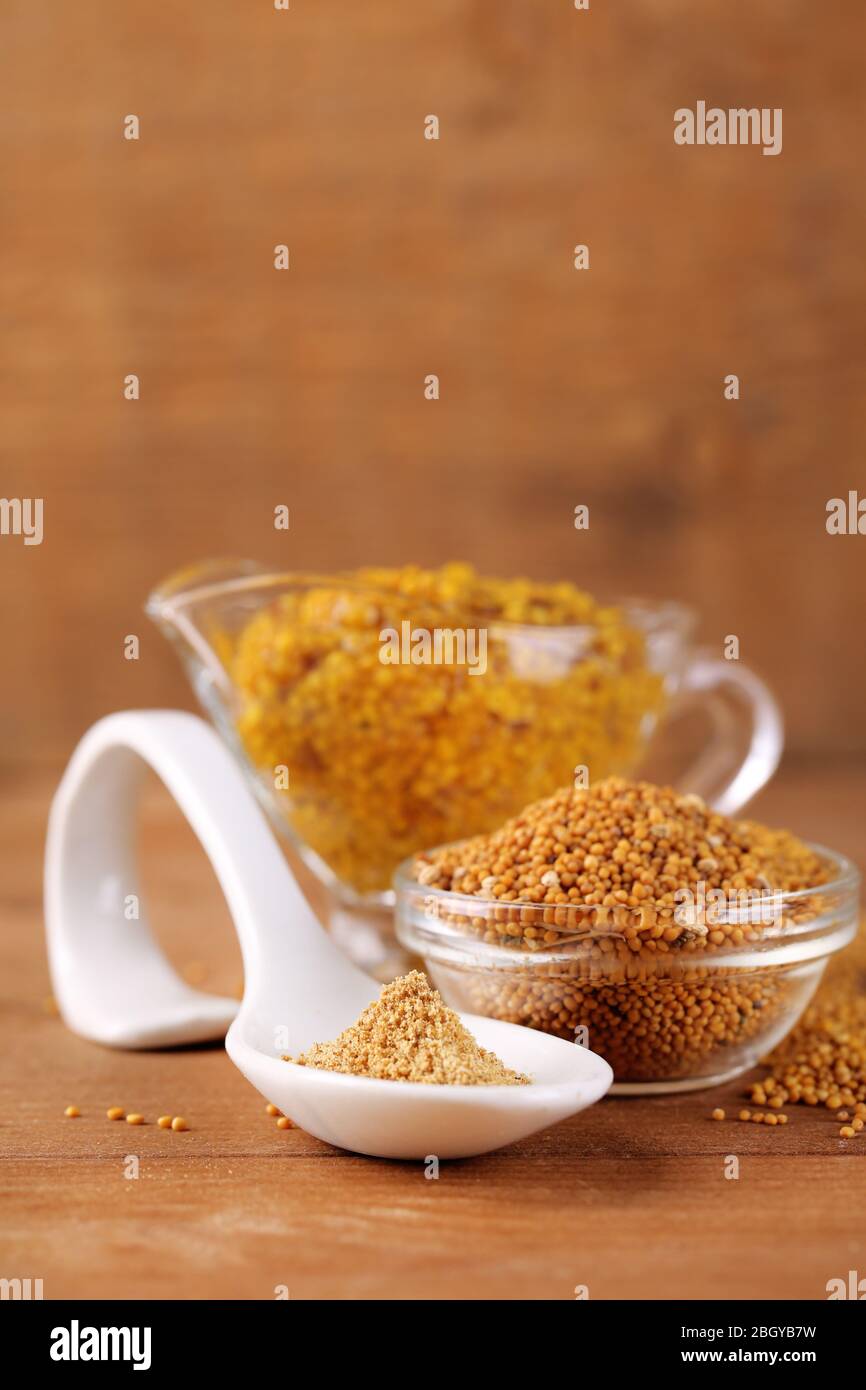 Composition of different kinds of mustard on color wooden background ...