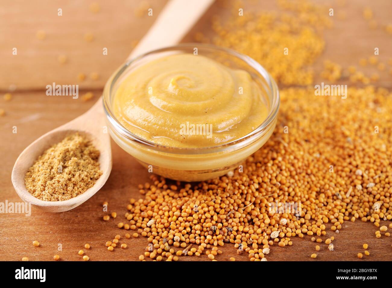 Composition of different kinds of mustard on wooden background Stock ...