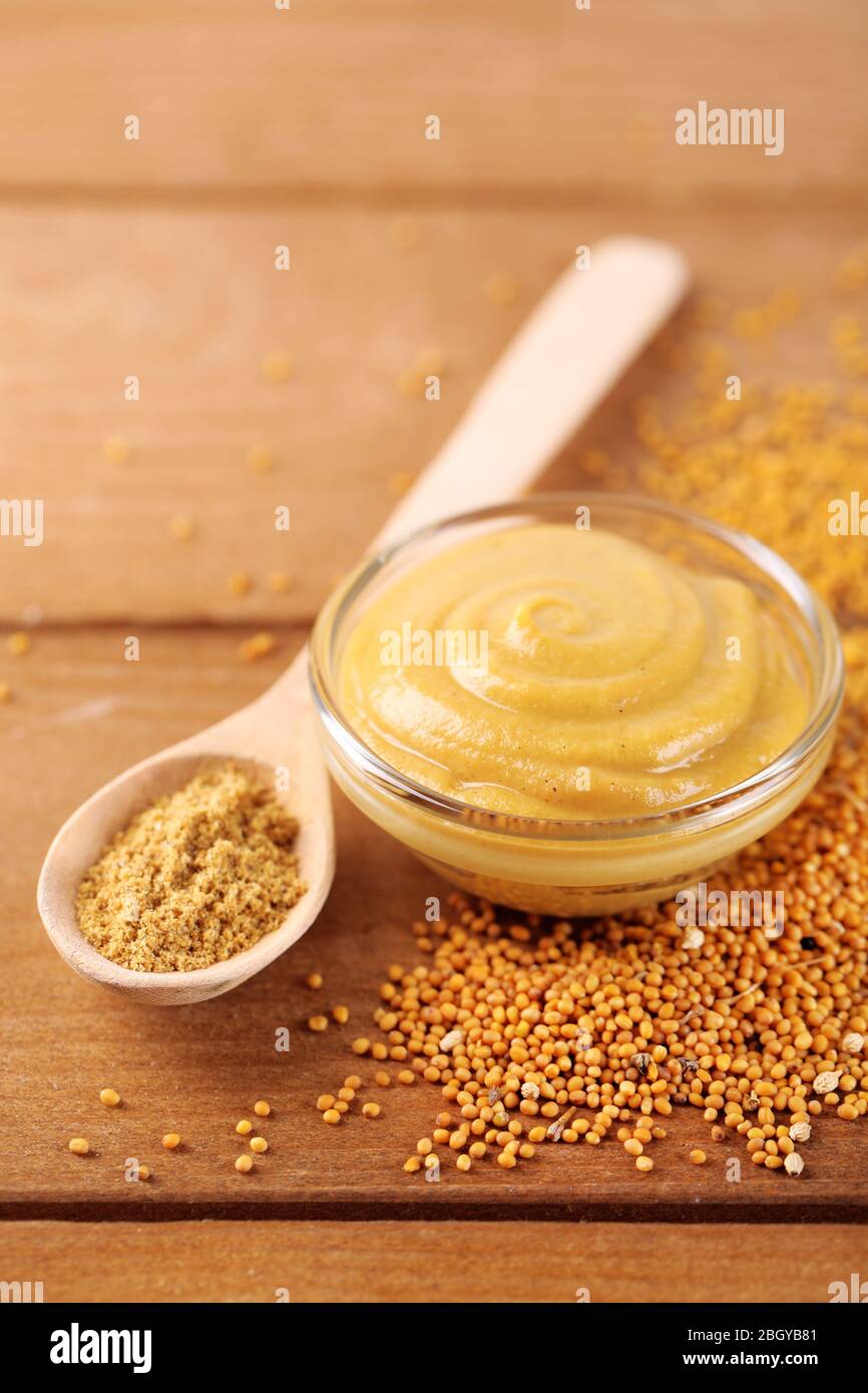 Composition of different kinds of mustard on wooden background Stock ...