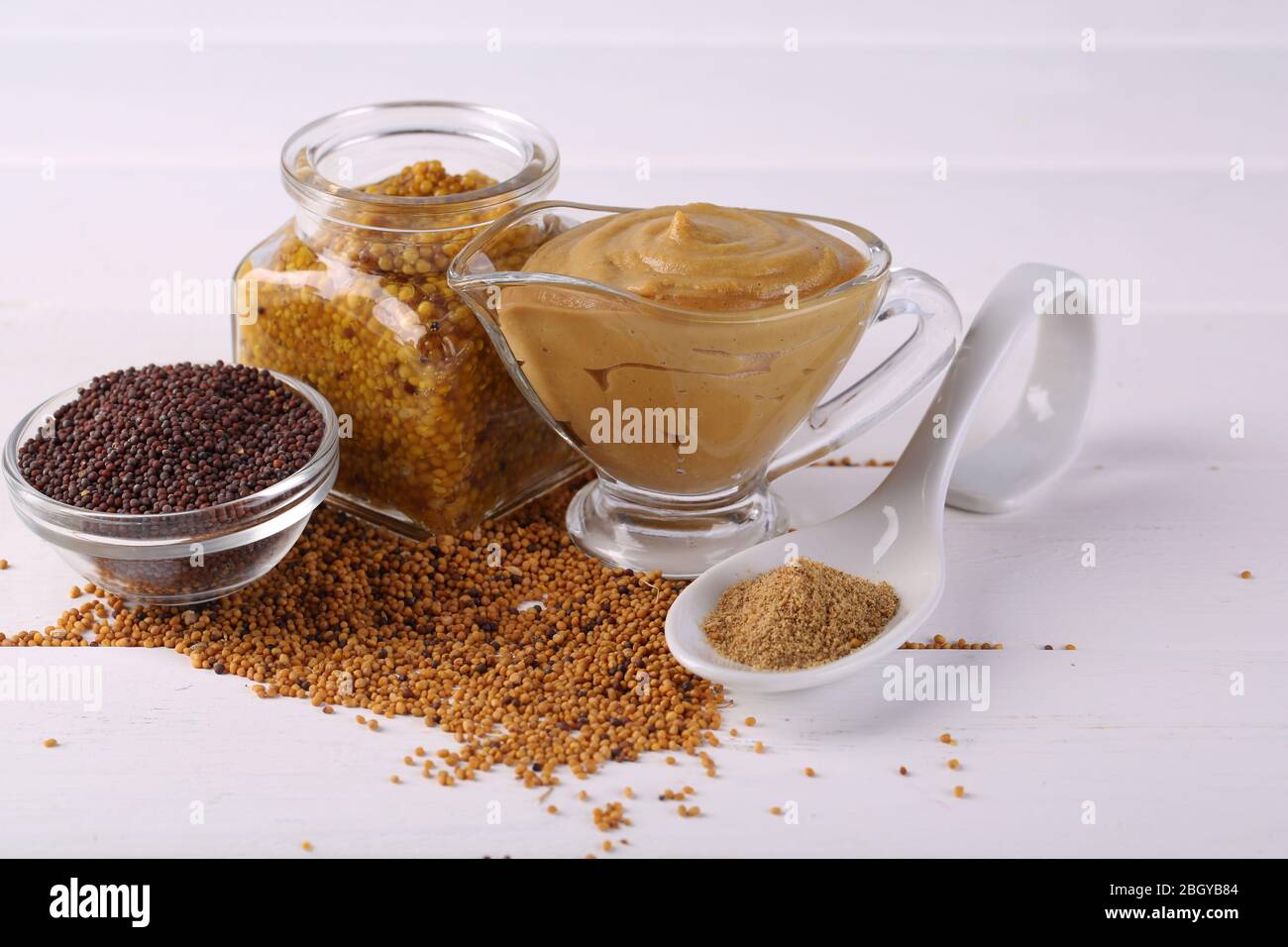 Composition of different kinds of mustard on color wooden background ...