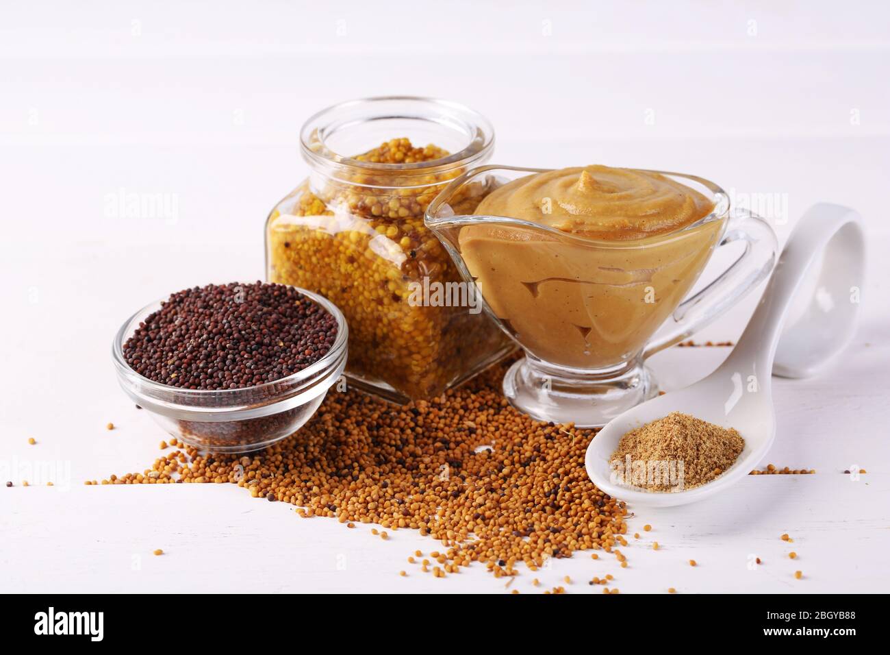 Composition of different kinds of mustard on color wooden background ...