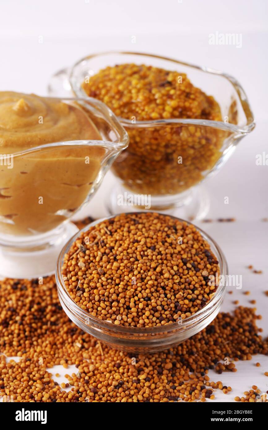 Composition of different kinds of mustard on color wooden background ...