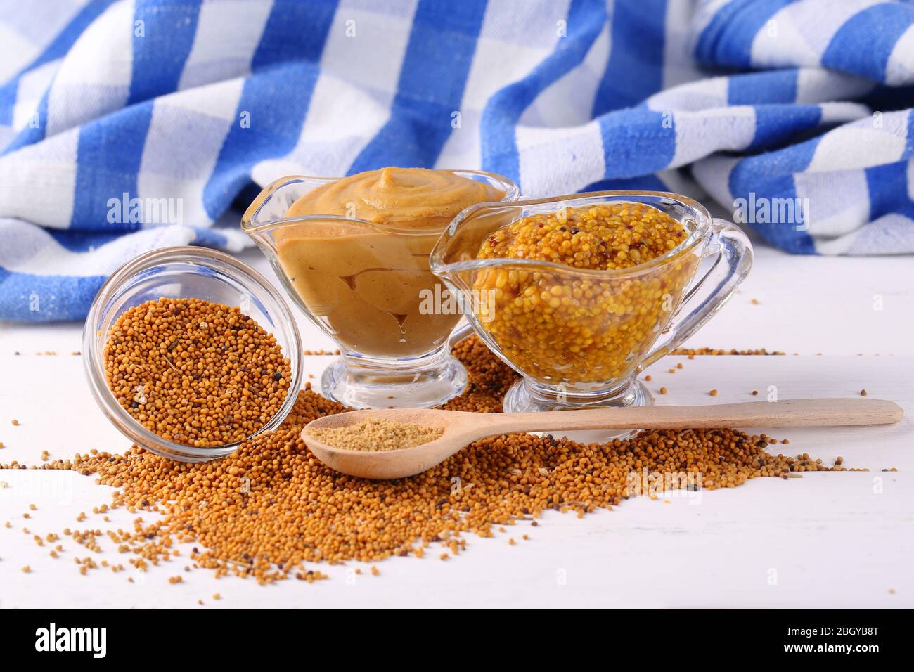 Composition of different kinds of mustard on color wooden background ...