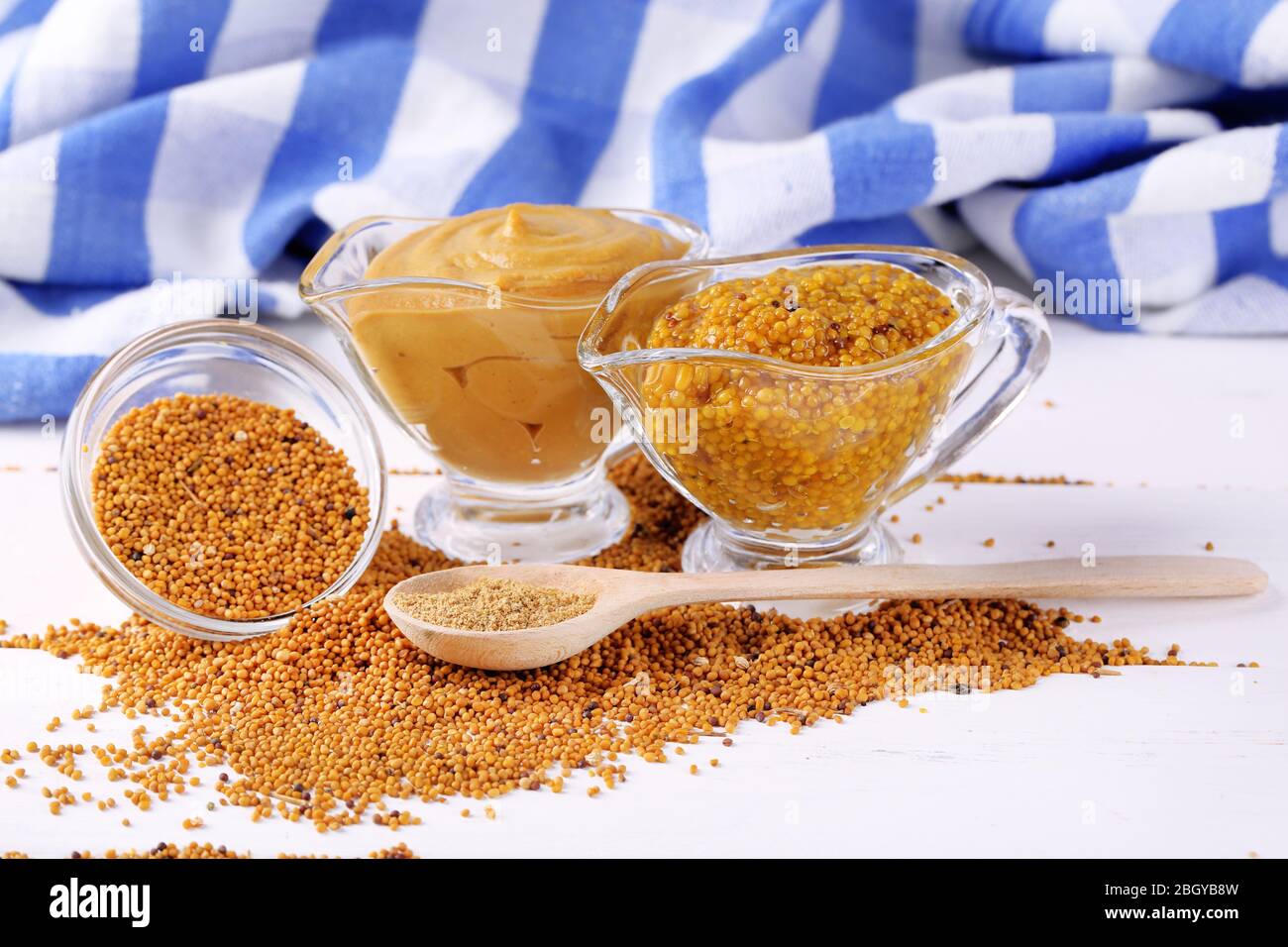 Composition of different kinds of mustard on color wooden background ...