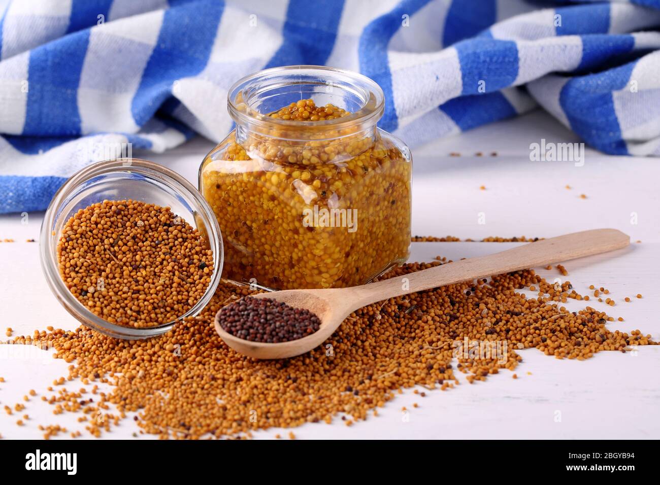 Composition of different kinds of mustard on color wooden background ...