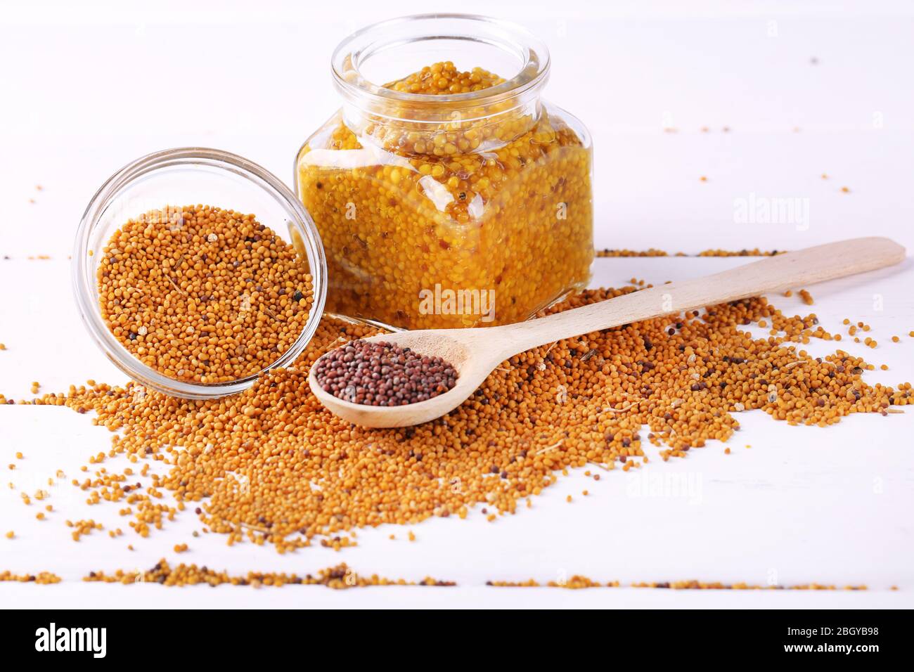Composition of different kinds of mustard on color wooden background ...
