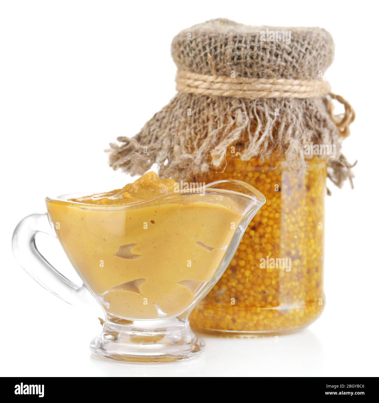 Assortment of mustard in glass jar and sauce-boat isolated on white ...