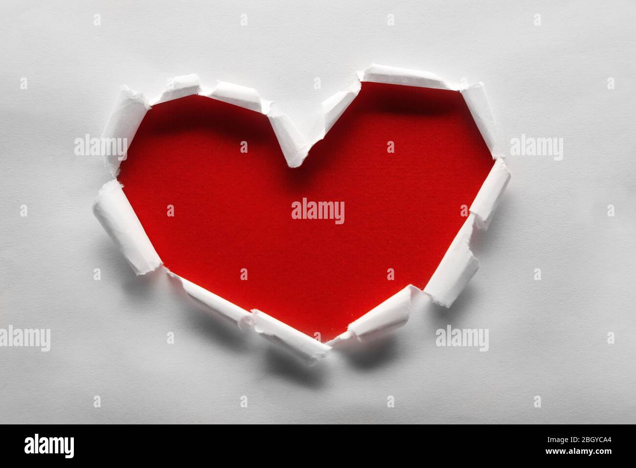 Torn paper heart over colorful background Stock Photo - Alamy