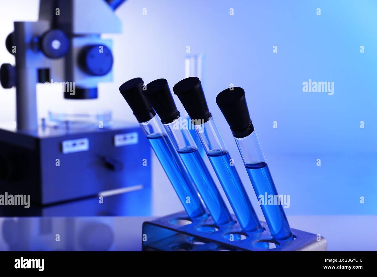 Laboratory glassware with blue liquid on bright background Stock Photo ...