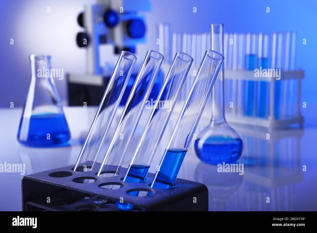 Laboratory glassware with blue liquid on bright background Stock Photo ...