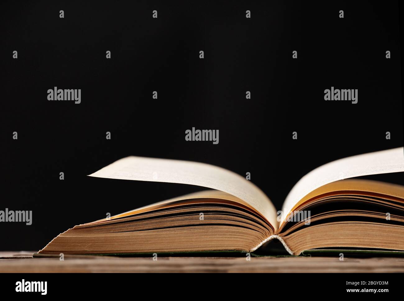 Open book with light over dark background Stock Photo - Alamy