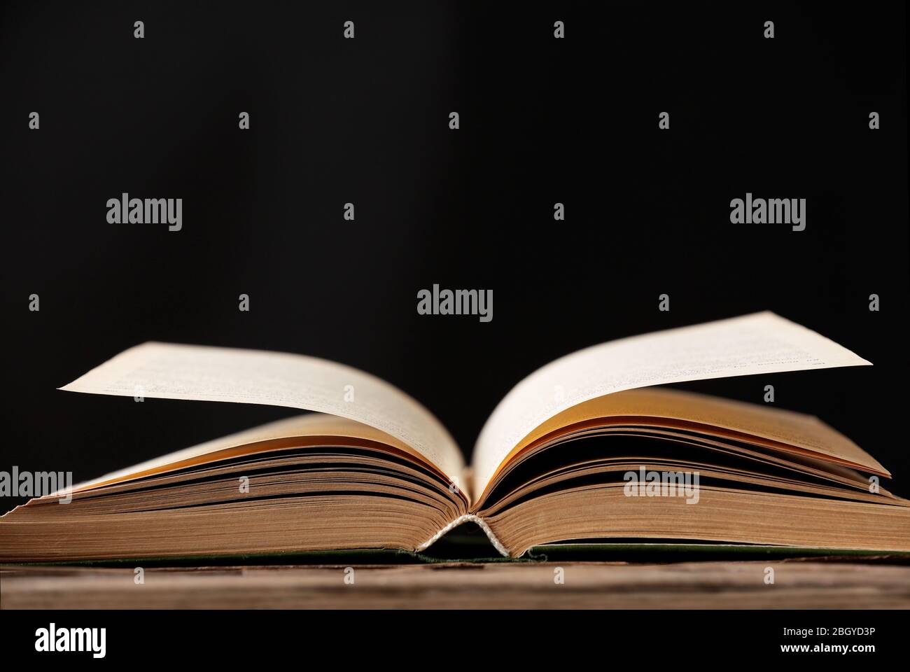 Open book with light over dark background Stock Photo - Alamy