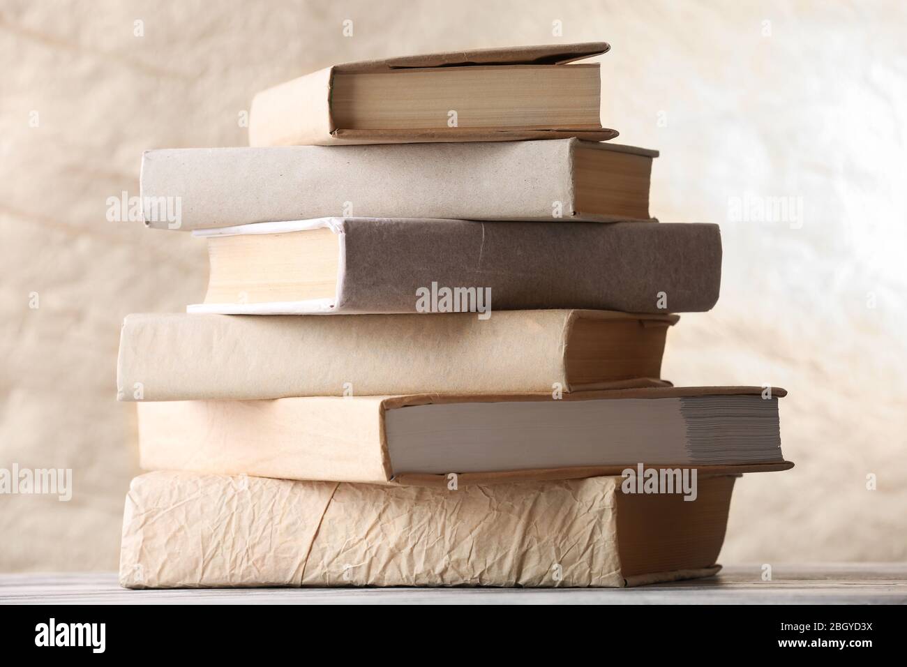 Stack of books on textured background Stock Photo - Alamy