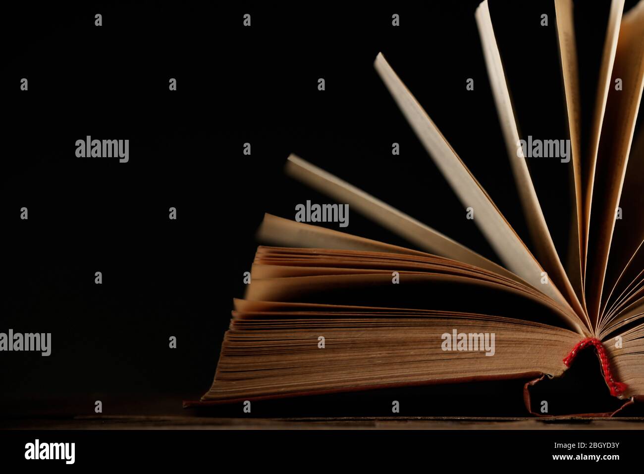 Open book with light over dark background Stock Photo - Alamy