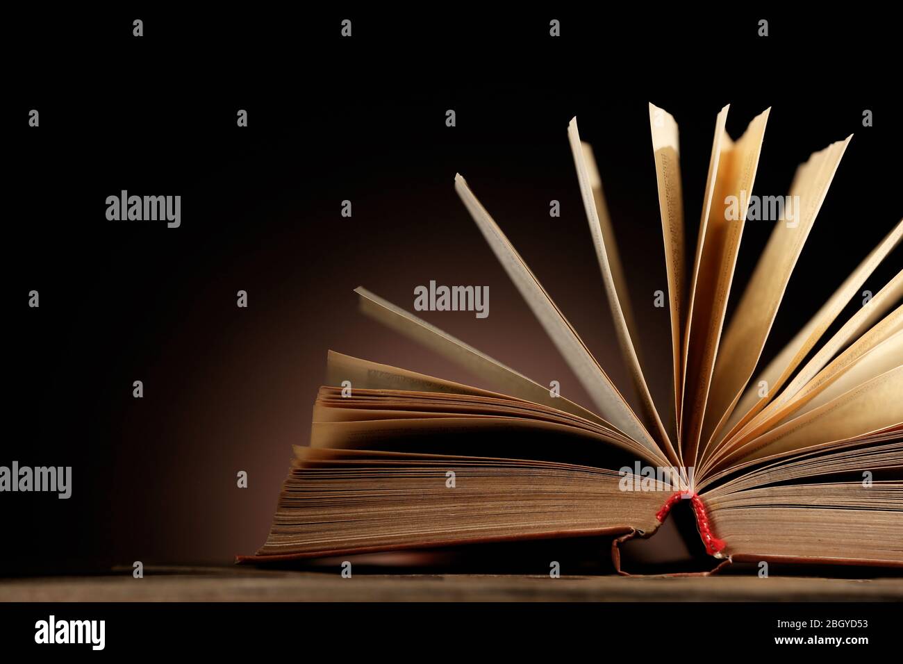 Open book with light over dark background Stock Photo - Alamy