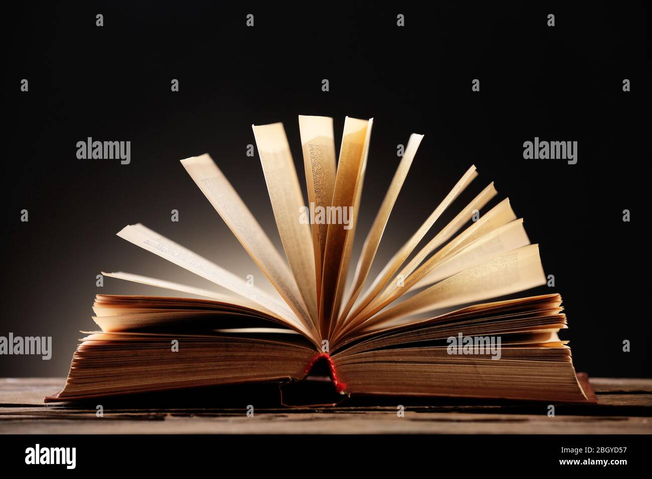 Open book with light over dark background Stock Photo - Alamy