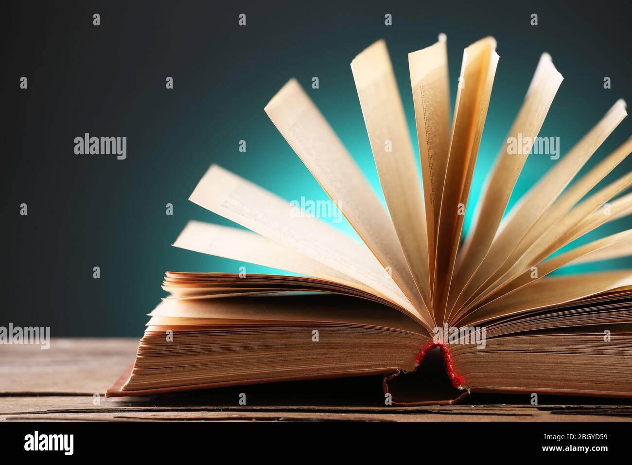 Open book over dark colorful background Stock Photo - Alamy