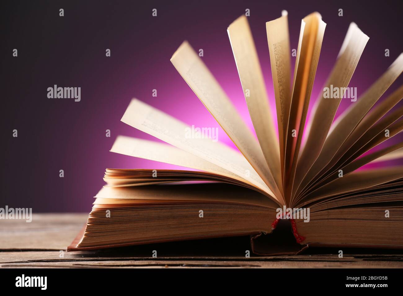 Open book over dark colorful background Stock Photo - Alamy