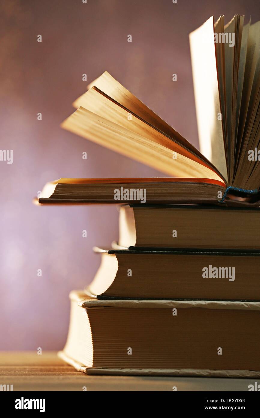 Books with light over dark background Stock Photo - Alamy
