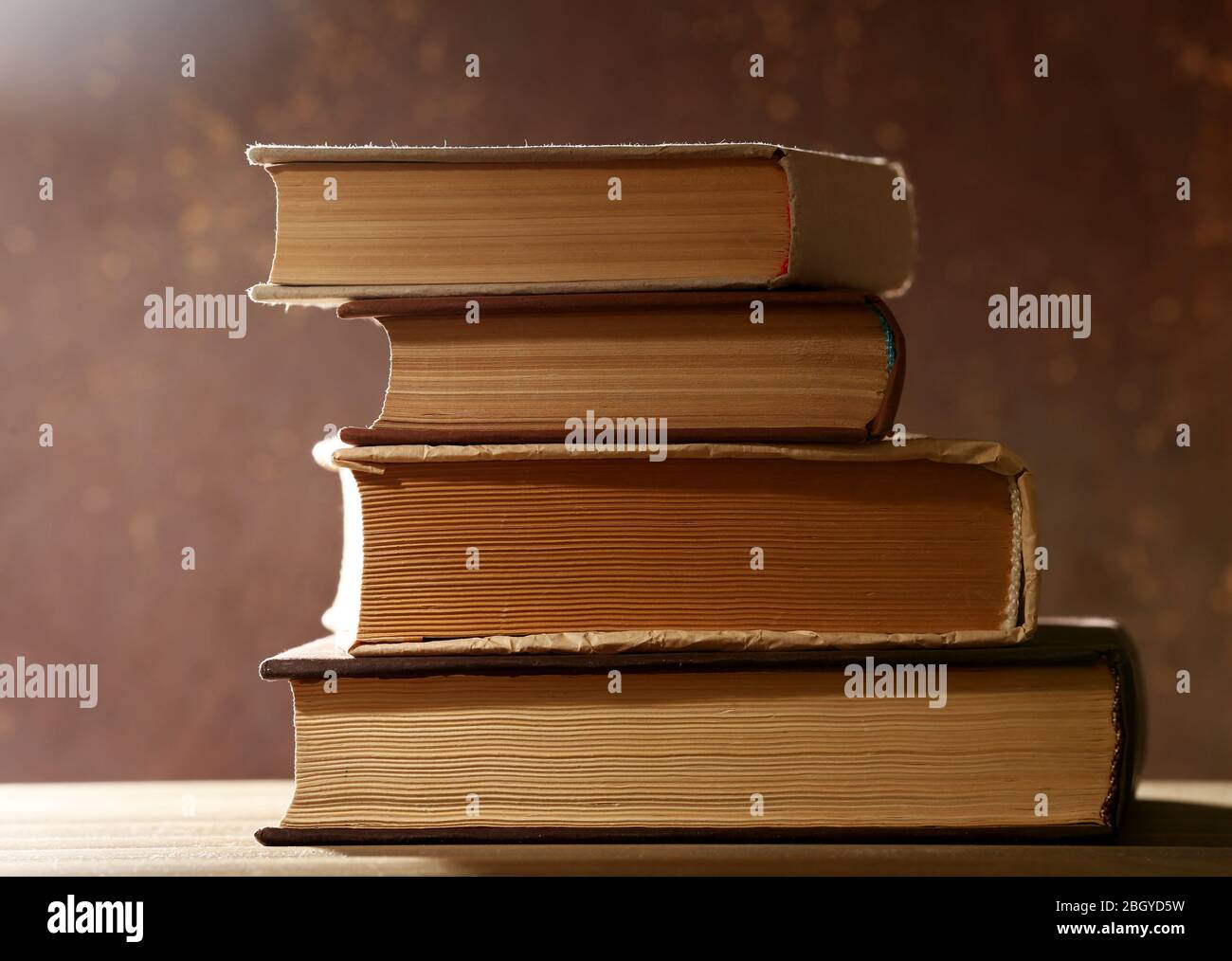 Books with light over dark background Stock Photo - Alamy
