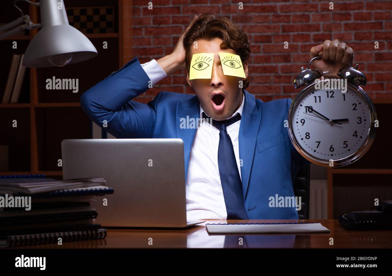 The young businessman working in the office at night Stock Photo - Alamy