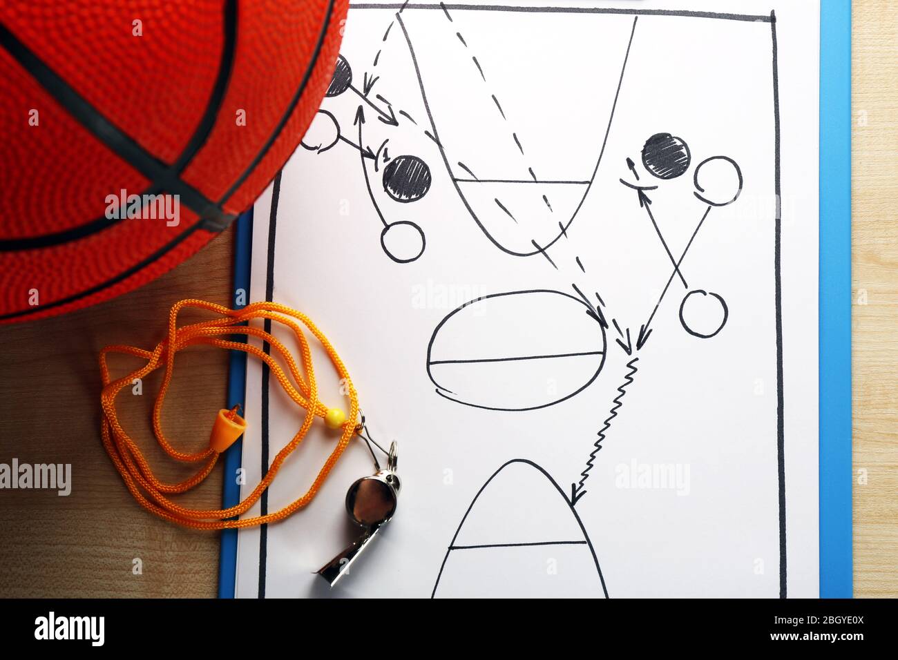 Scheme basketball game on sheet of paper with basketball on wooden ...