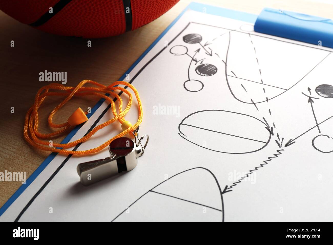 Scheme basketball game on sheet of paper with basketball on wooden ...