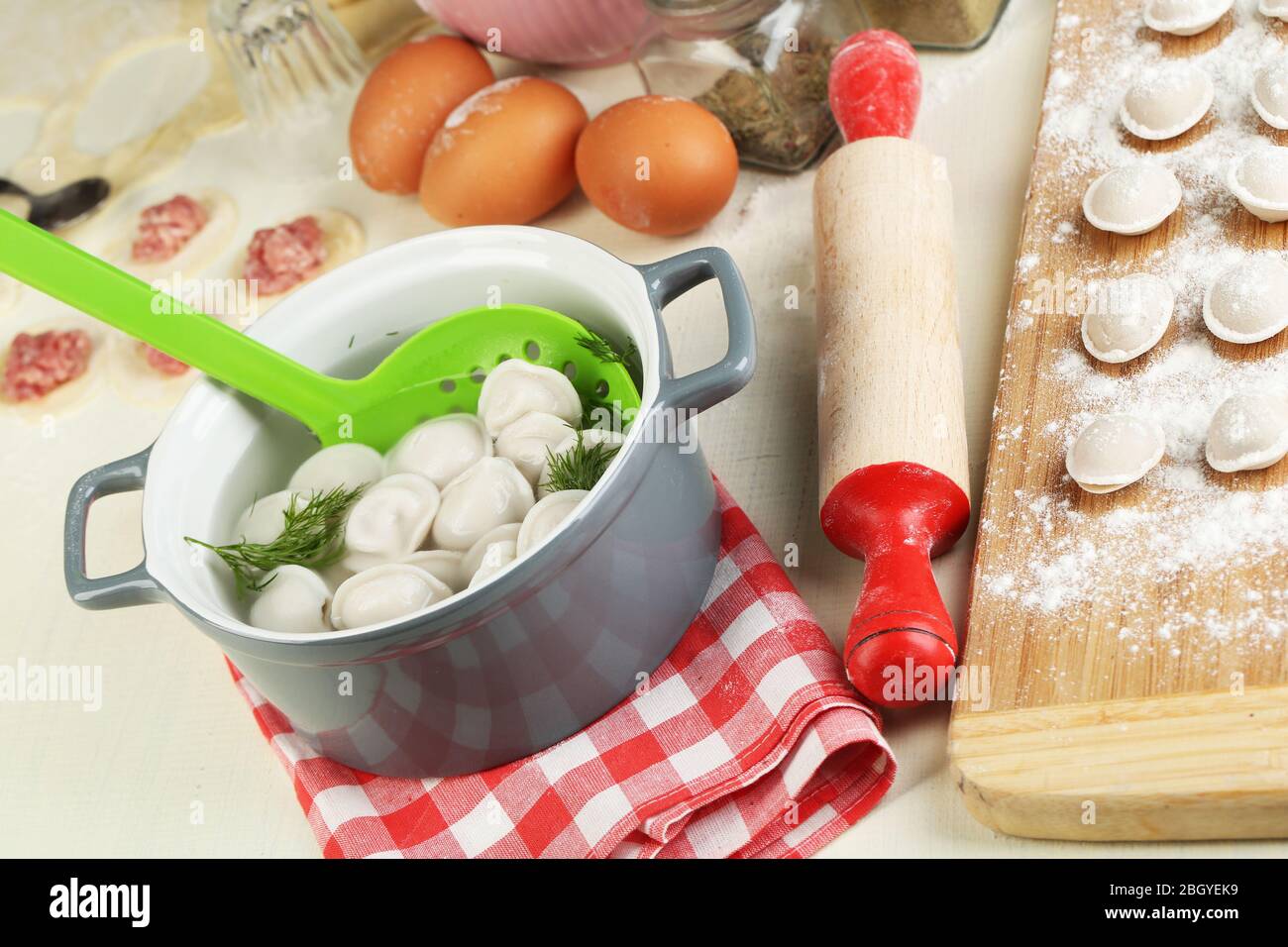 Raw and cooked dumplings close-up in kitchen Stock Photo - Alamy