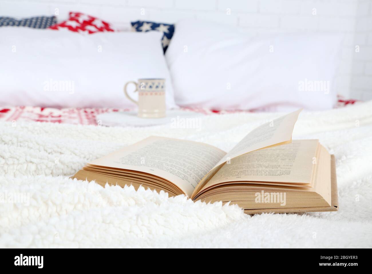 Book on bed close-up Stock Photo - Alamy