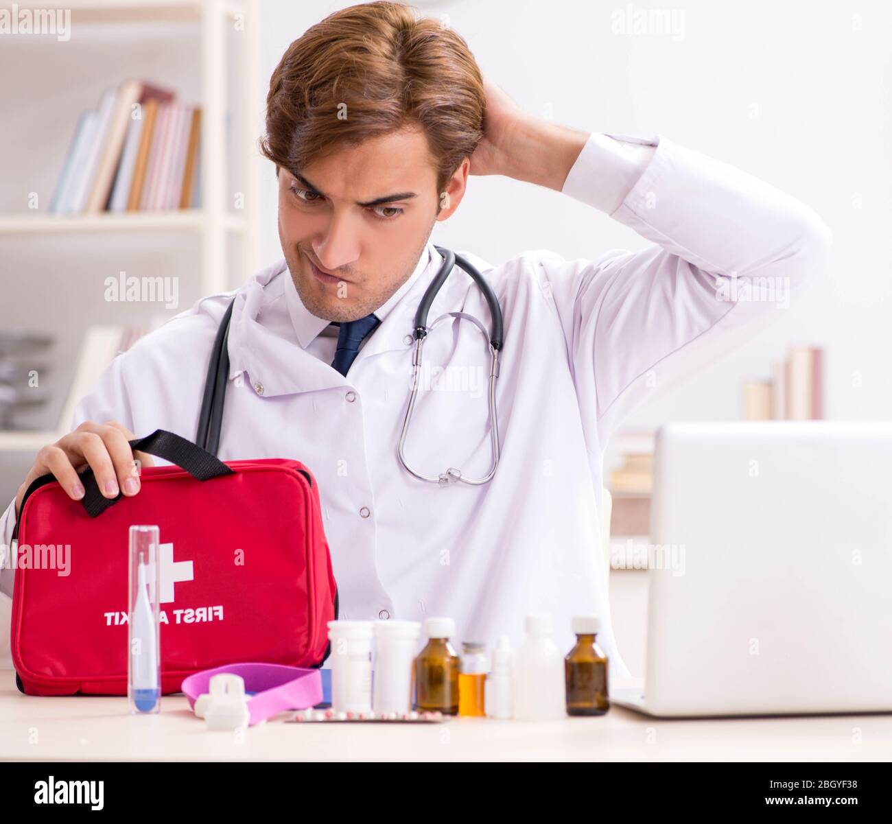 The young doctor with first aid kit in hospital Stock Photo - Alamy