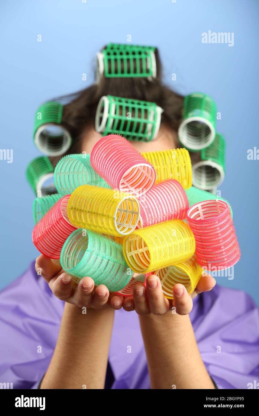 Girl in hair curlers on colorful background Stock Photo - Alamy