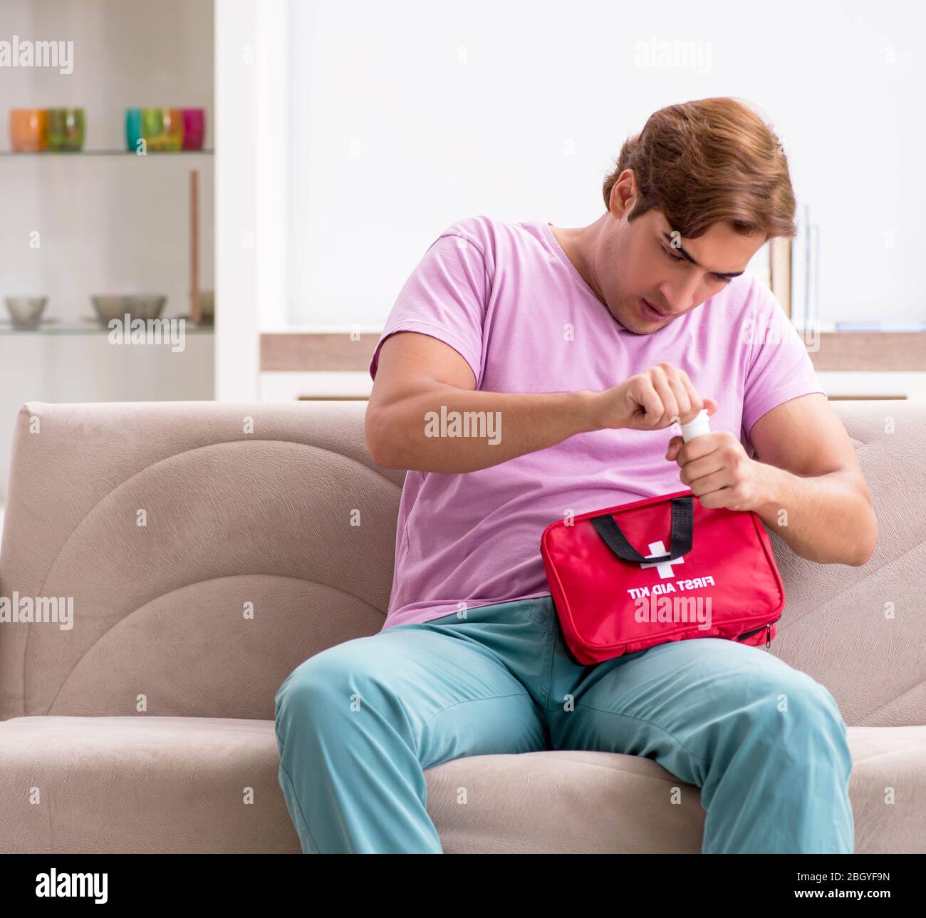 The sick man at home with first aid kit Stock Photo - Alamy