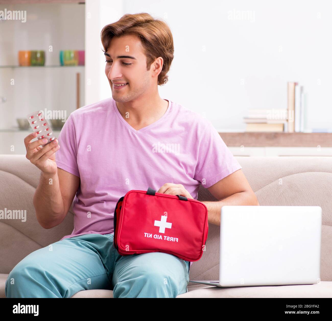 The sick man at home with first aid kit Stock Photo - Alamy