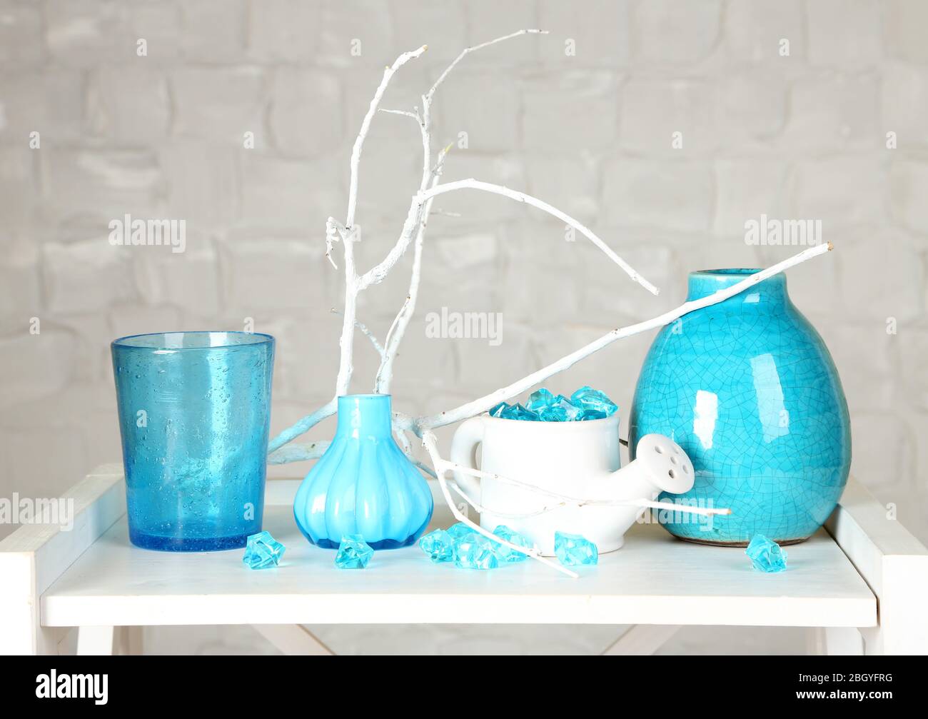 Interior with decorative vases and branch twig on table top and white ...