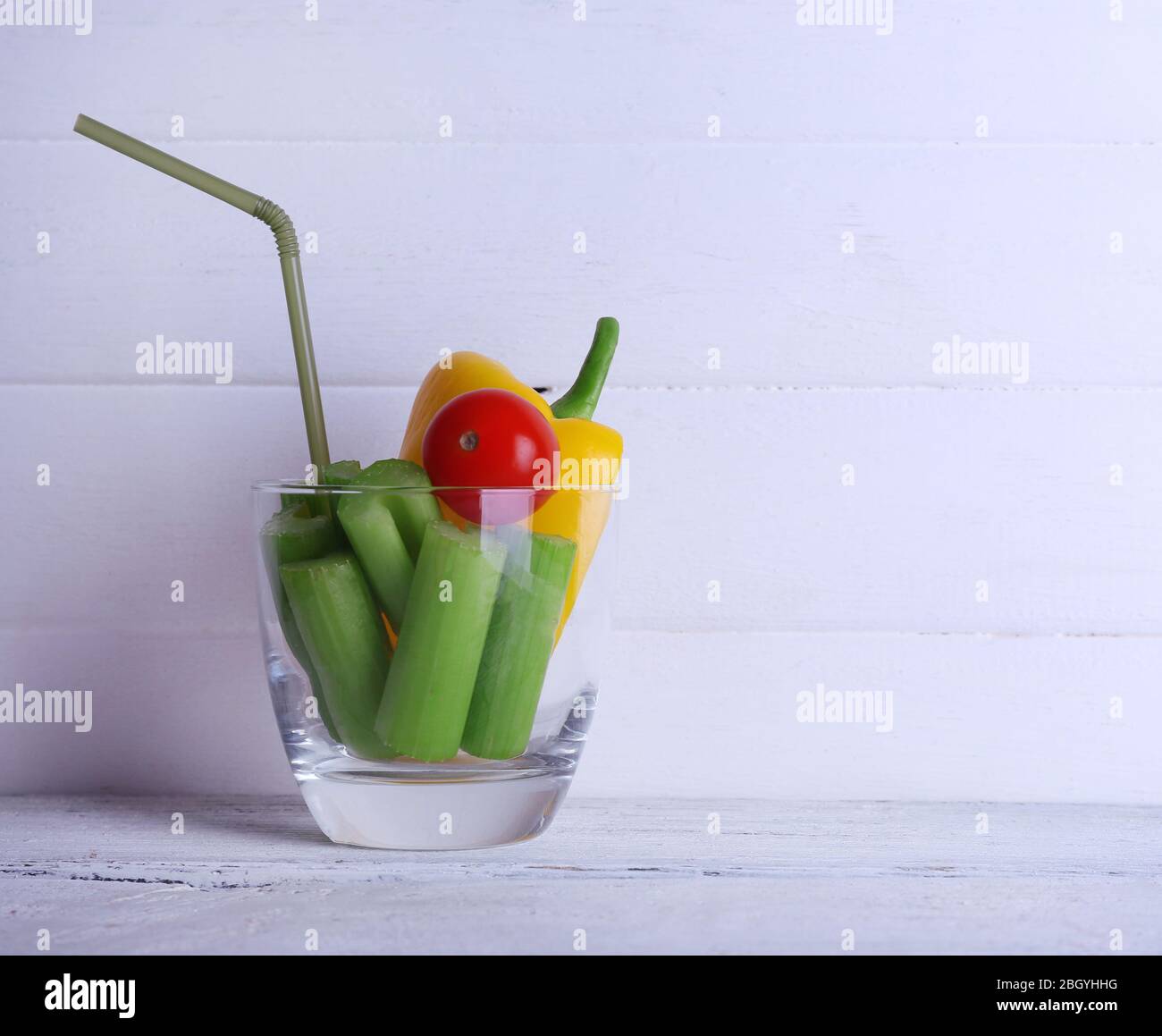 Vegetables in glass with tube on color wooden planks background Stock ...